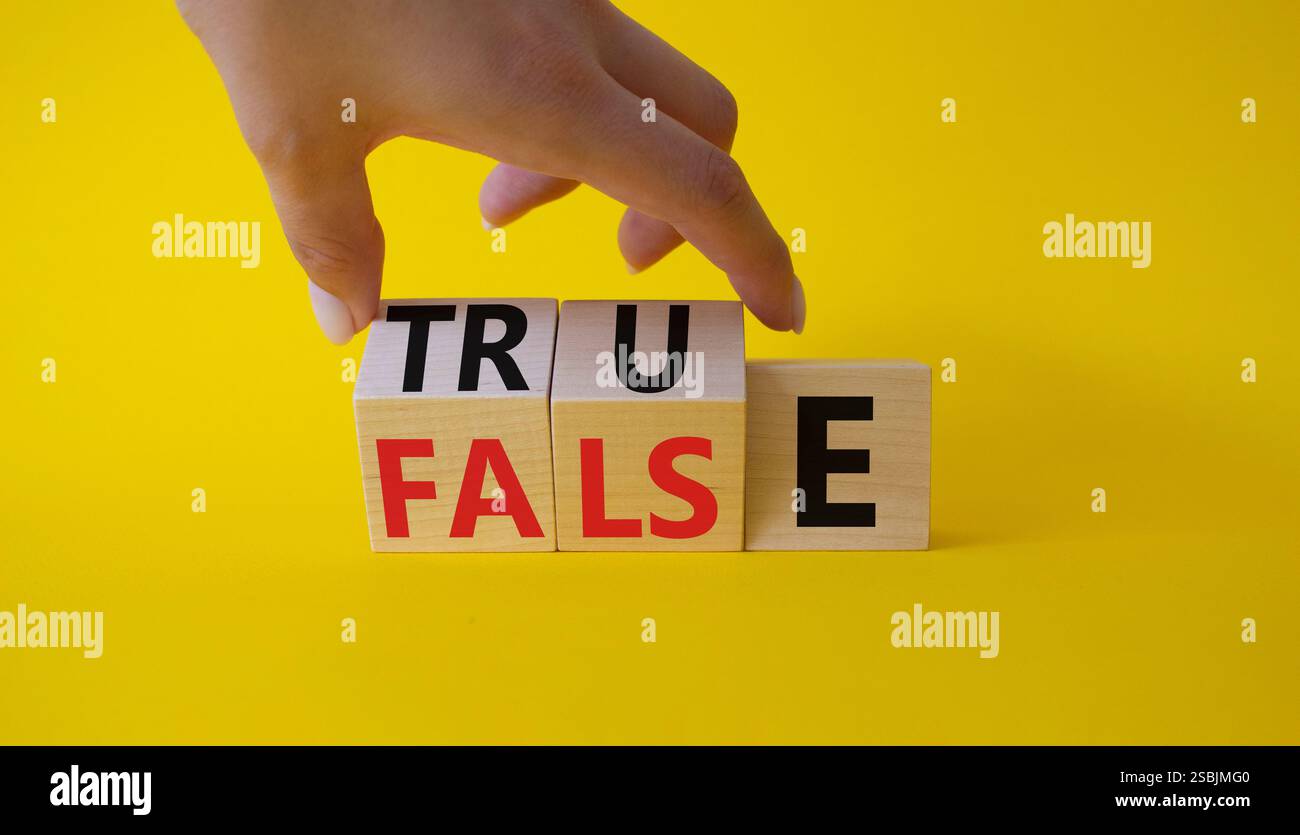 True vs False symbol. Businessman Hand turns cubes and changes word ...