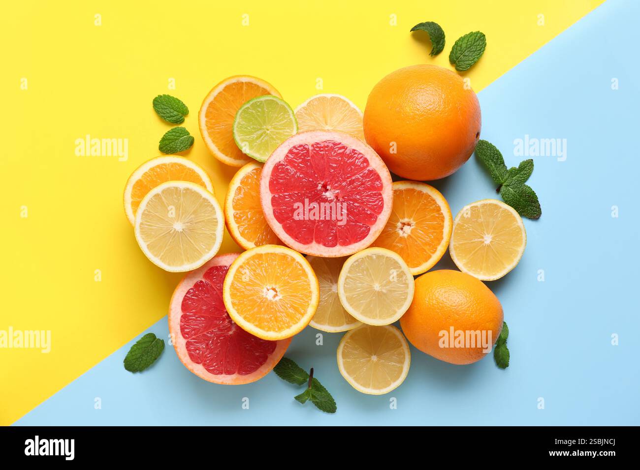 Different cut citrus fruits with mint leaves on color background Stock ...