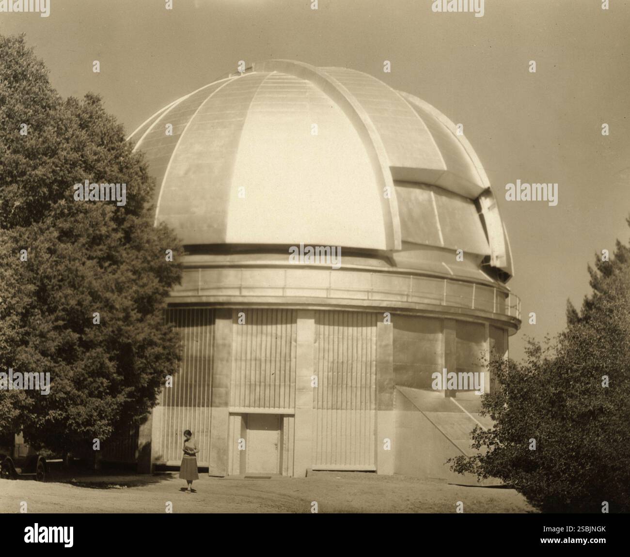 A woman standing in front of the 60-inch telescope dome, Mount Wilson ...