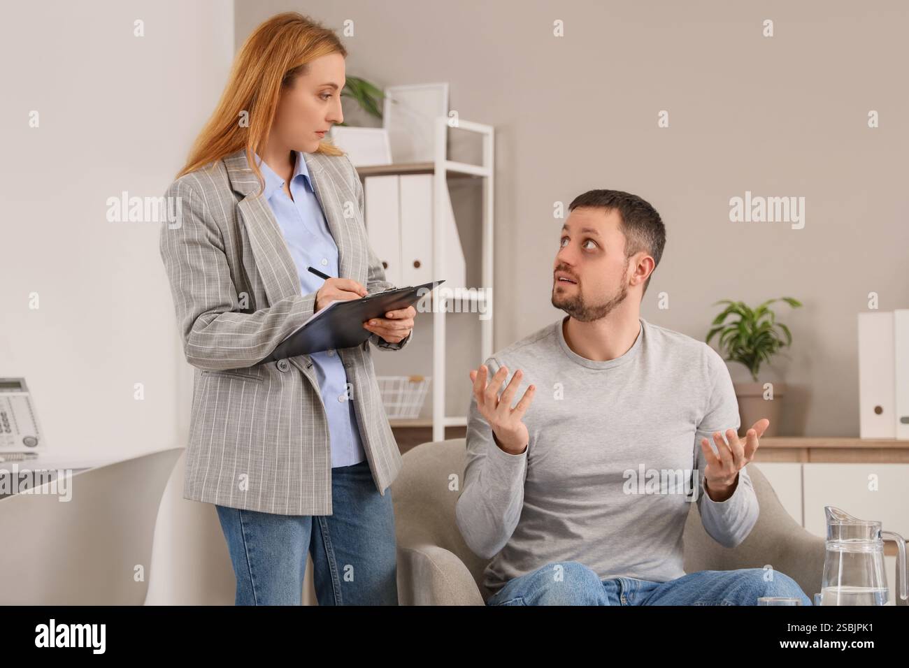 Male drug addict talking to psychologist in office Stock Photo - Alamy