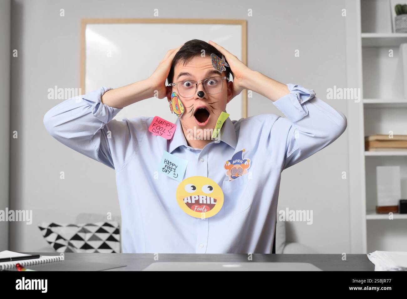 Shocked businessman with drawn whiskers and sticky papers in office ...