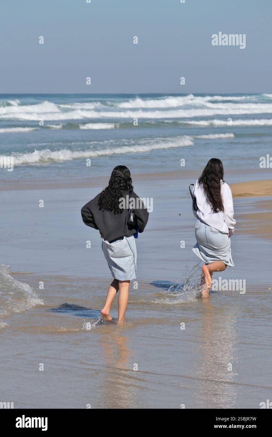 Two women walking on the beach in Netanya, Israel in winter Stock Photo ...