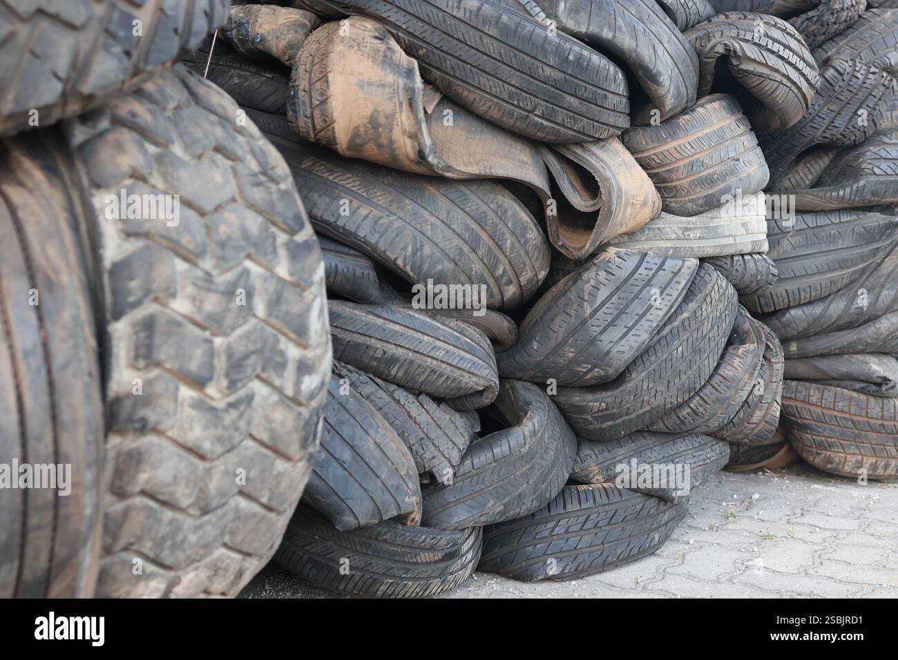 A large pile of used and worn-out tyres stacked at an inland port ...