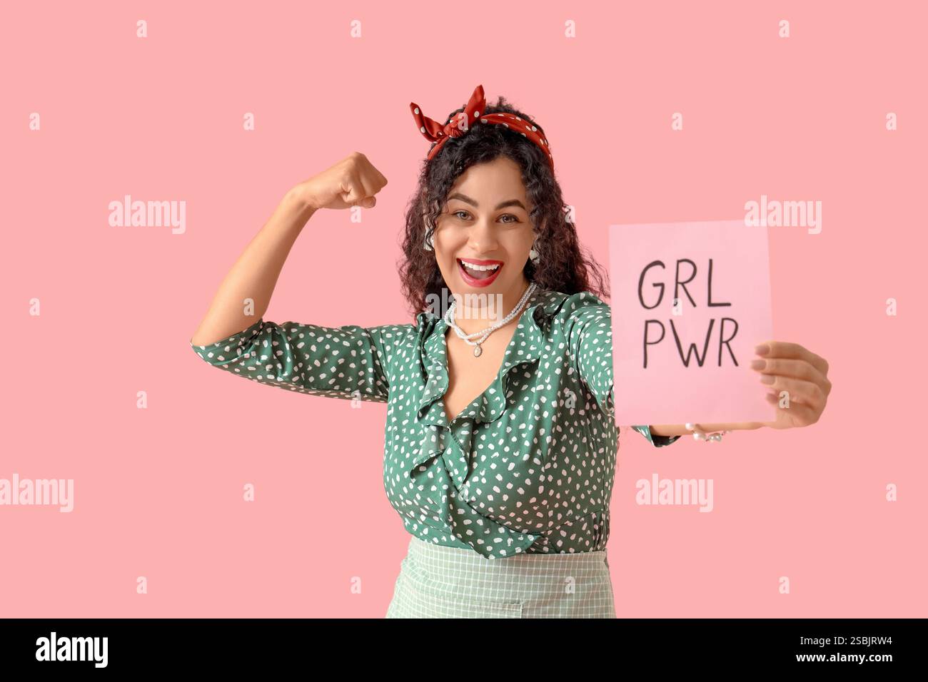 Young African-American pin-up woman with GRL PWR sign showing muscles ...