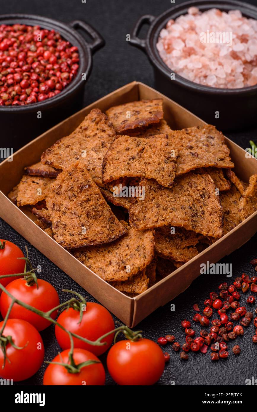 Crispy homemade brown bread chips with seeds and grains, salt, spices ...