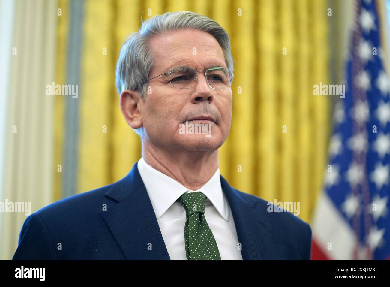 Treasury Secretary Scott Bessent listens as President Donald Trump ...