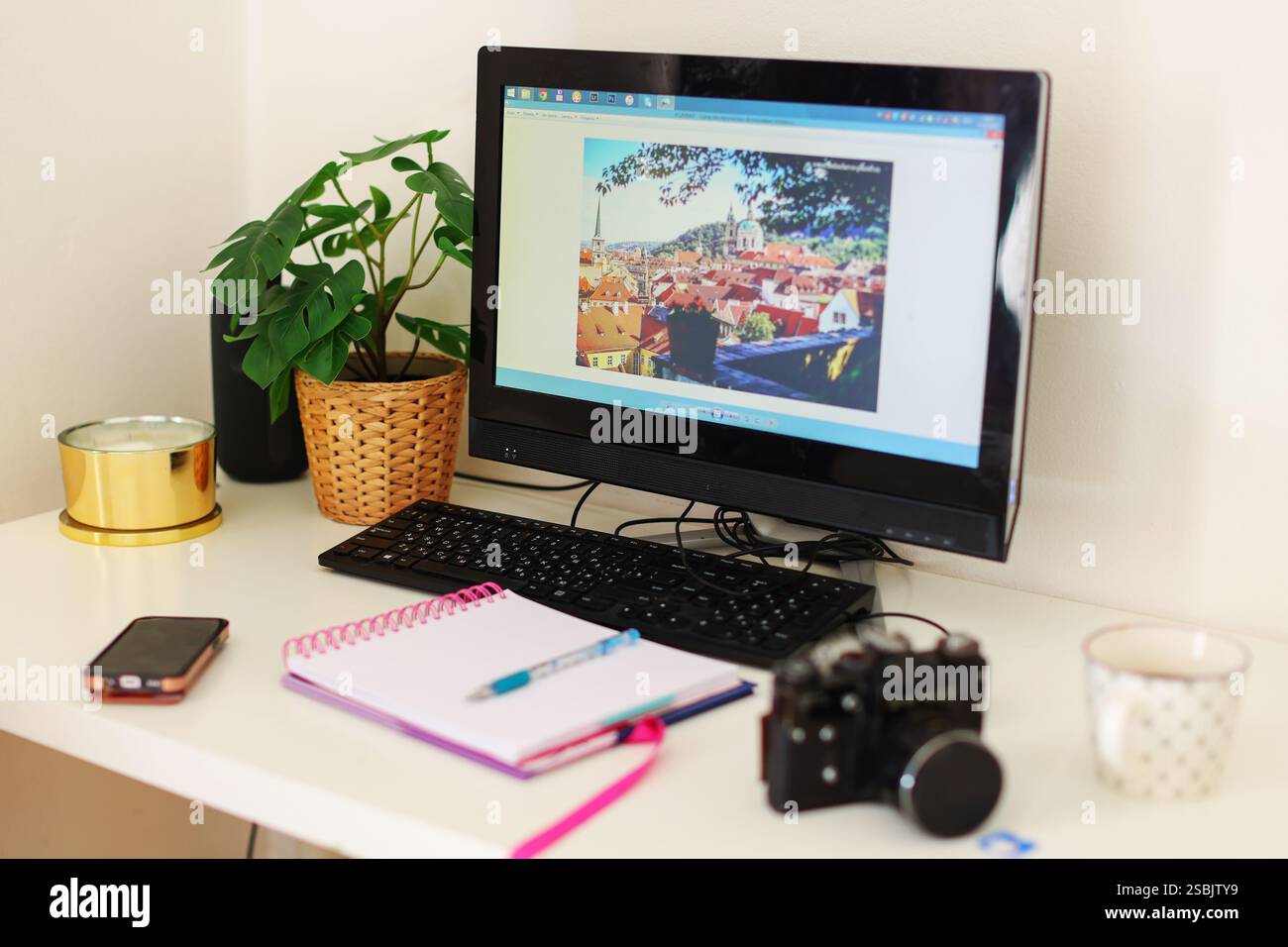 Office table with laptop, camera diary and a cup of tea Stock Photo - Alamy