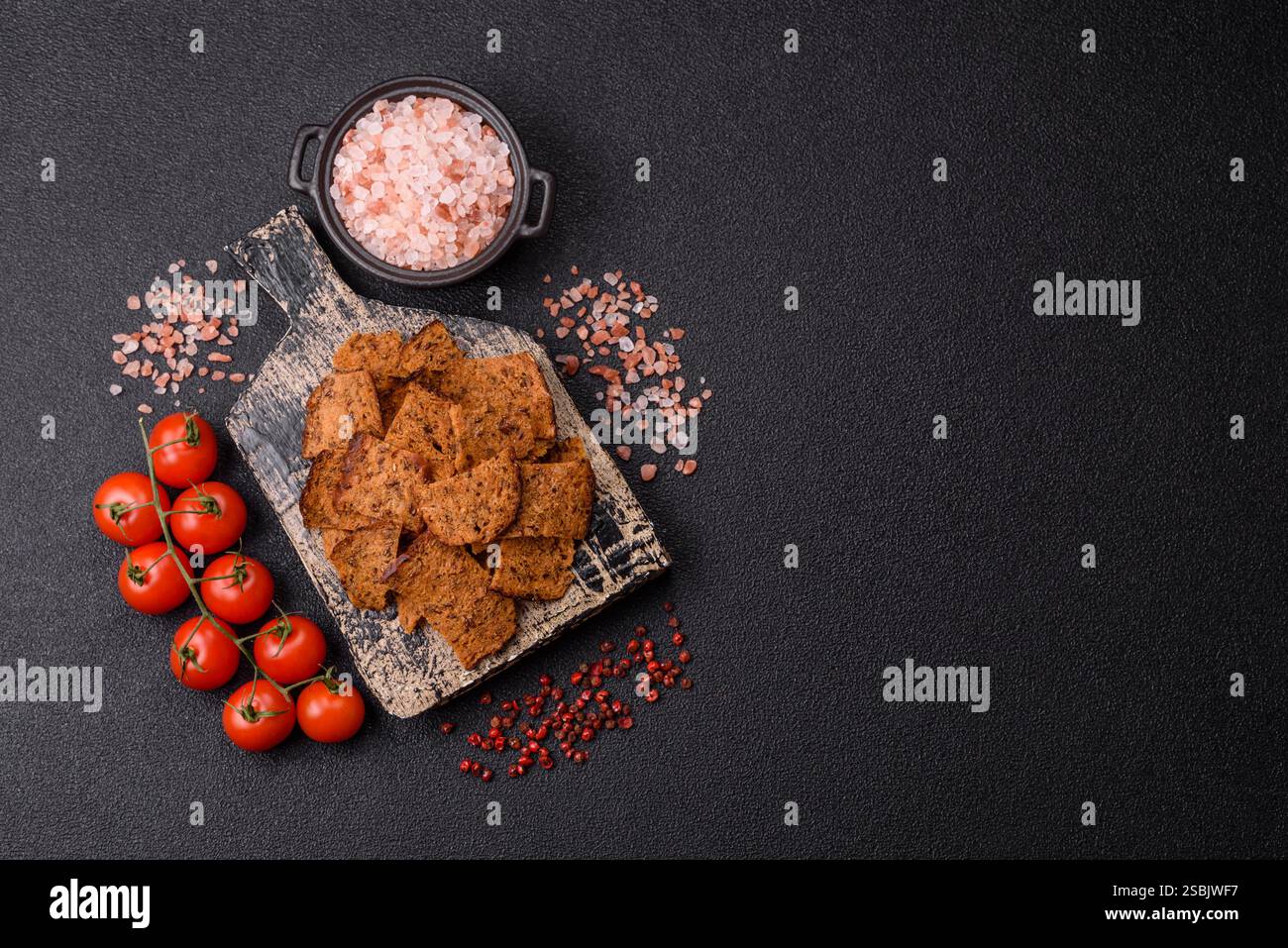 Crispy homemade brown bread chips with seeds and grains, salt, spices ...