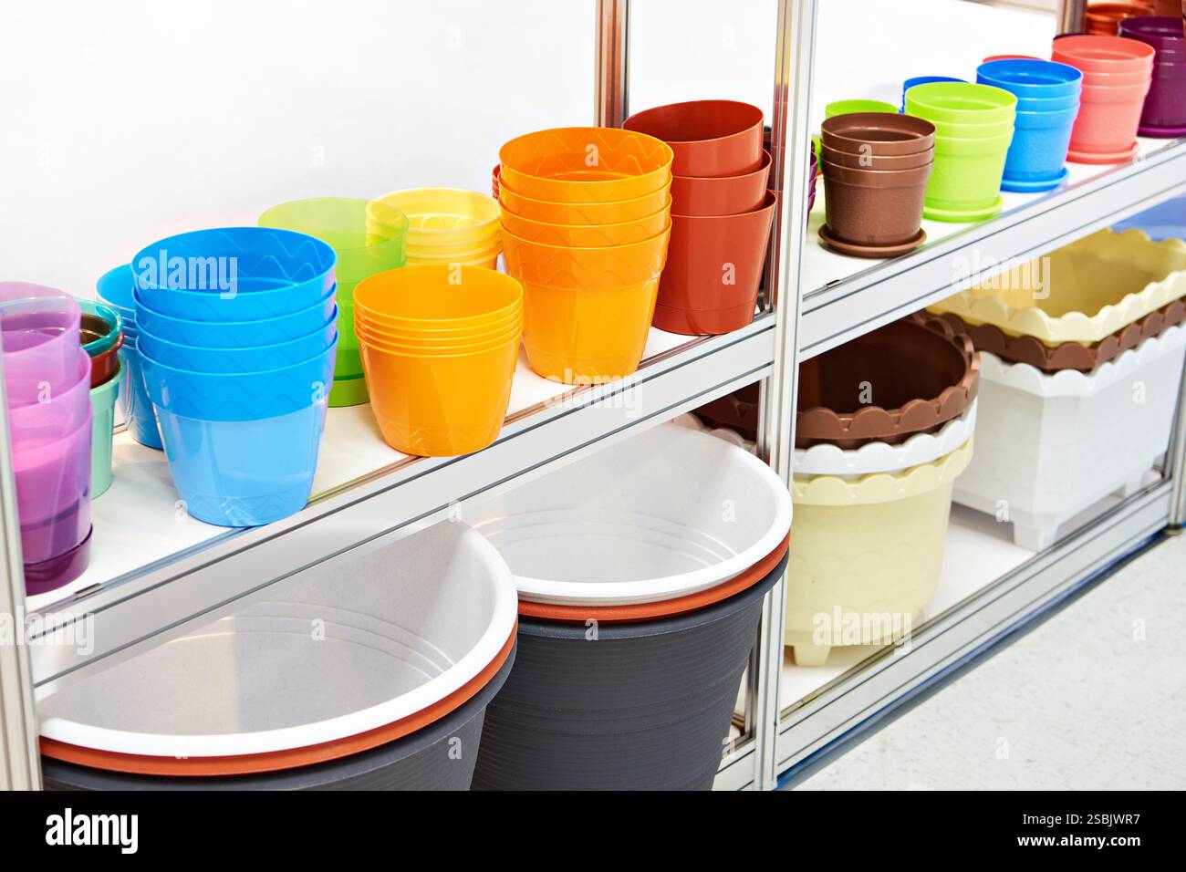 Colored plastic plant pots in store Stock Photo - Alamy