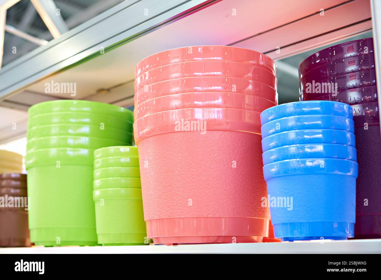 Colored plastic plant pots in store Stock Photo - Alamy