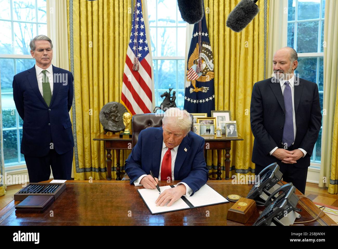 President Donald Trump signs an executive order as Treasury Secretary ...