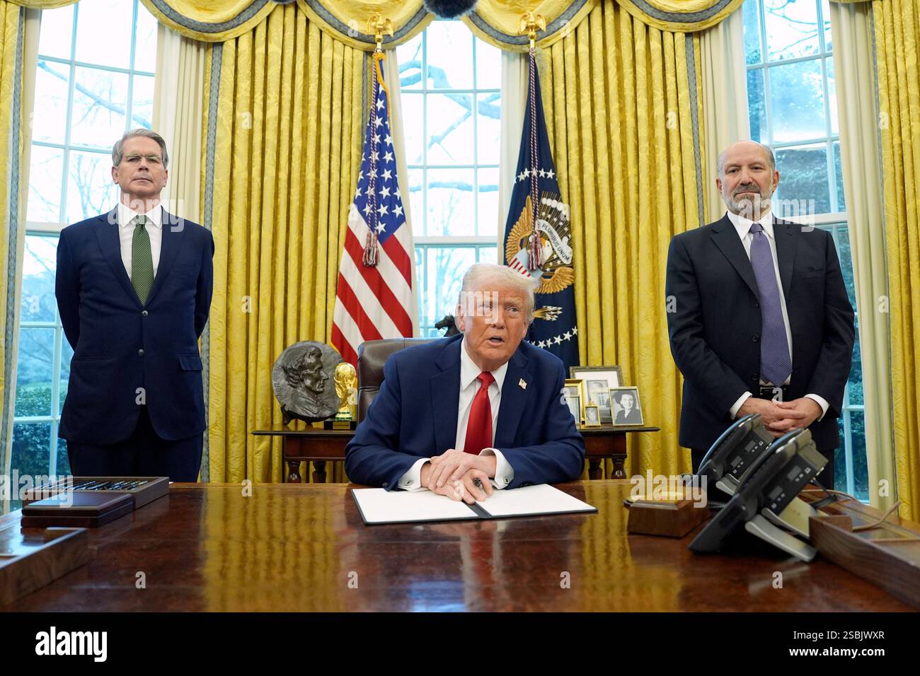 President Donald Trump speaks as Treasury Secretary Scott Bessent, left ...