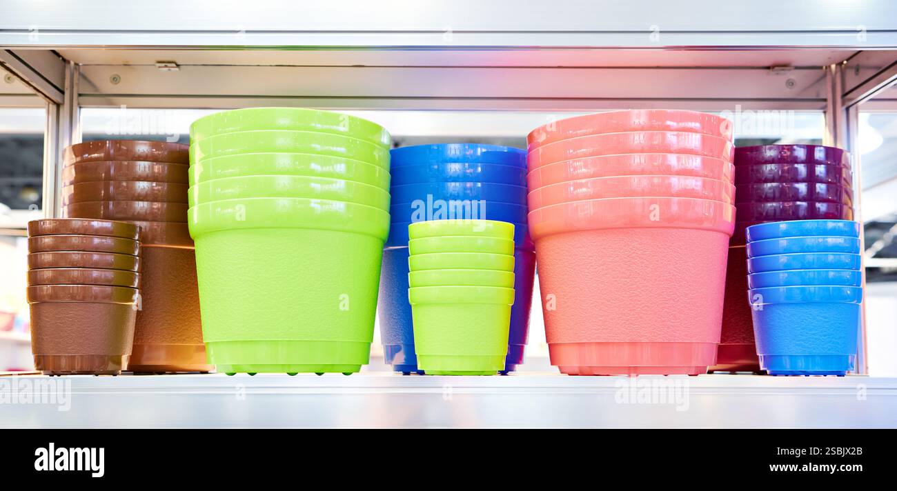 Colored plastic plant pots in store Stock Photo - Alamy