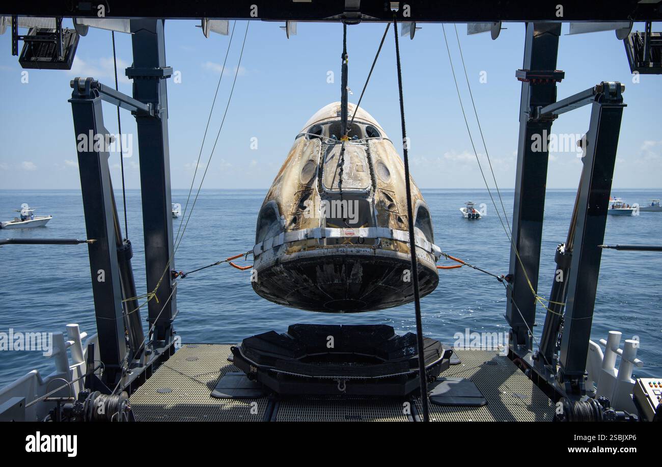 The SpaceX Crew Dragon Endeavour spacecraft is lifted onto the SpaceX ...