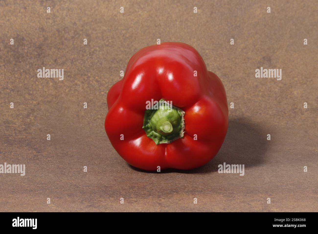 The fruit of red sweet bell pepper on a brown tabletop background Stock ...