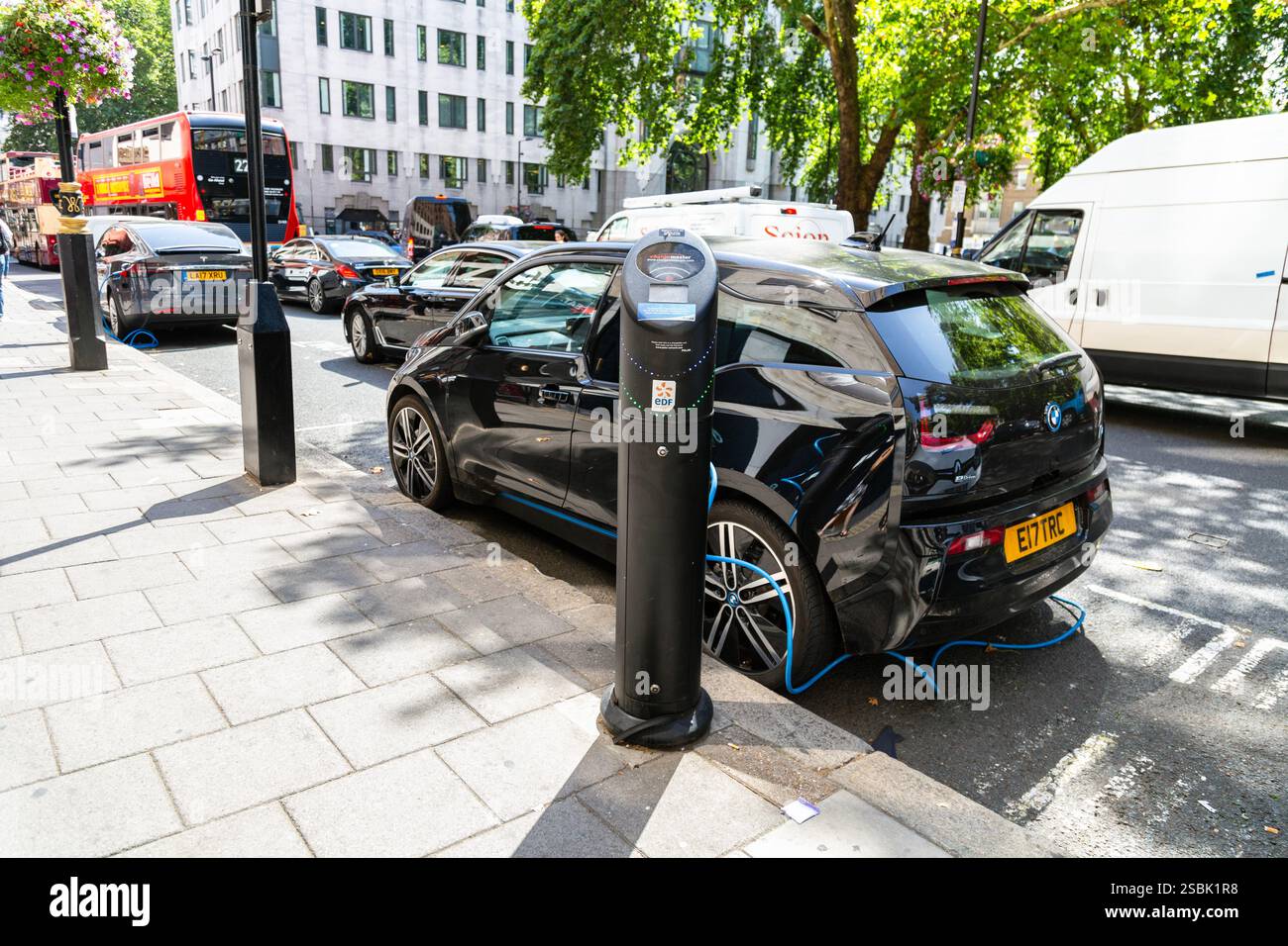 Electric car plugged in to an on-street EV charging point, Mayfair ...