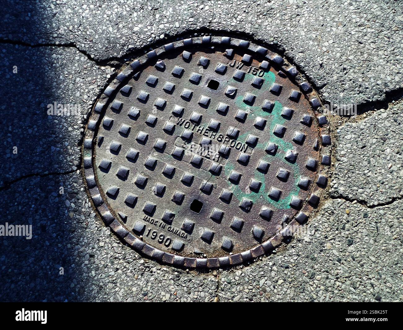 Iron manhole/sewer covers in London Ontario Stock Photo - Alamy