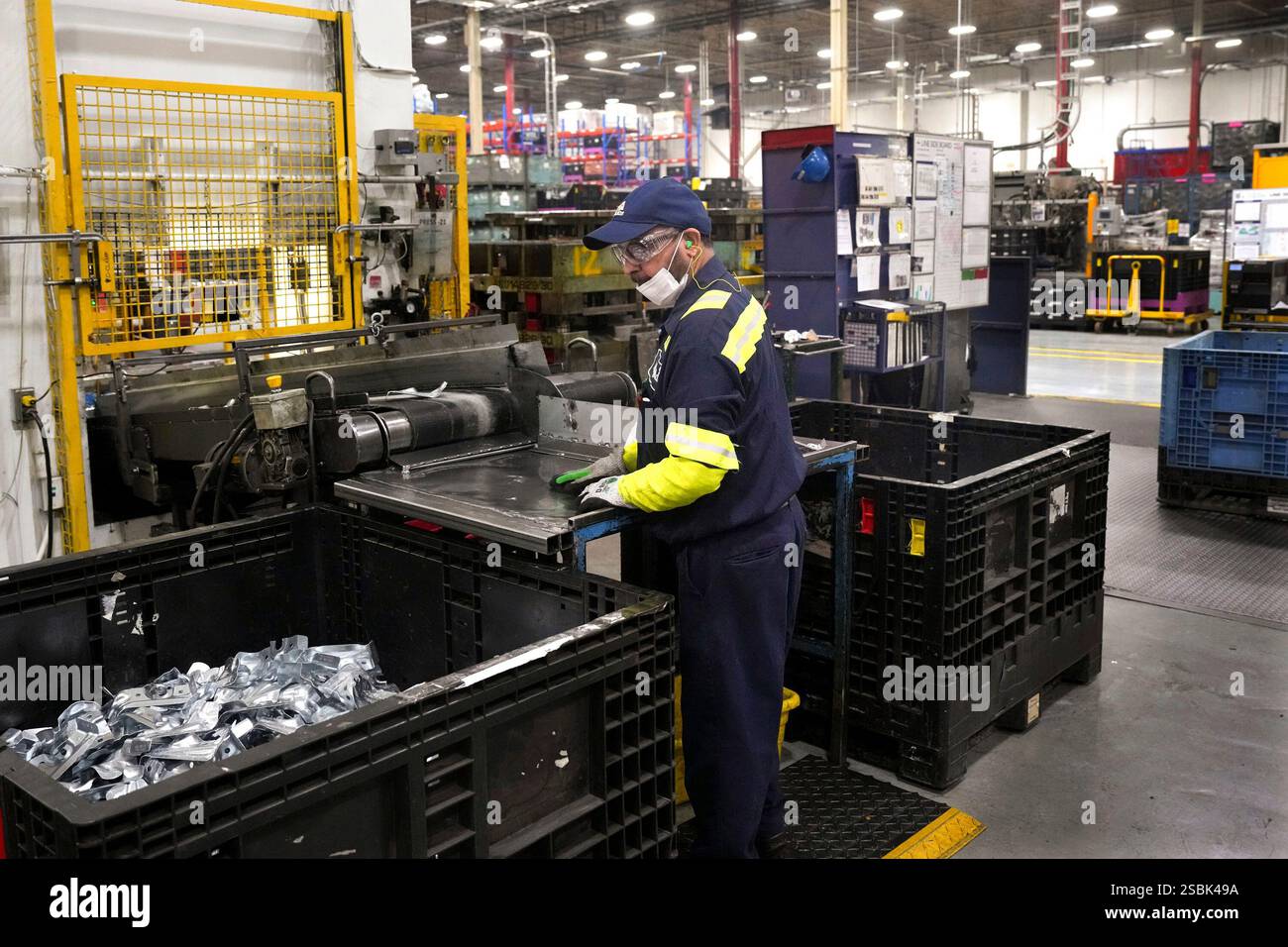 An employee works on the production line at the Martinrea auto parts ...