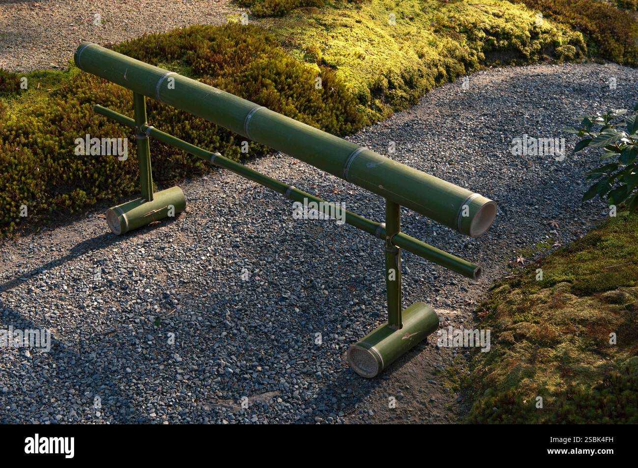 Horizontal bamboo "kekkai" (barrier) on a garden pathway indicates "Do ...