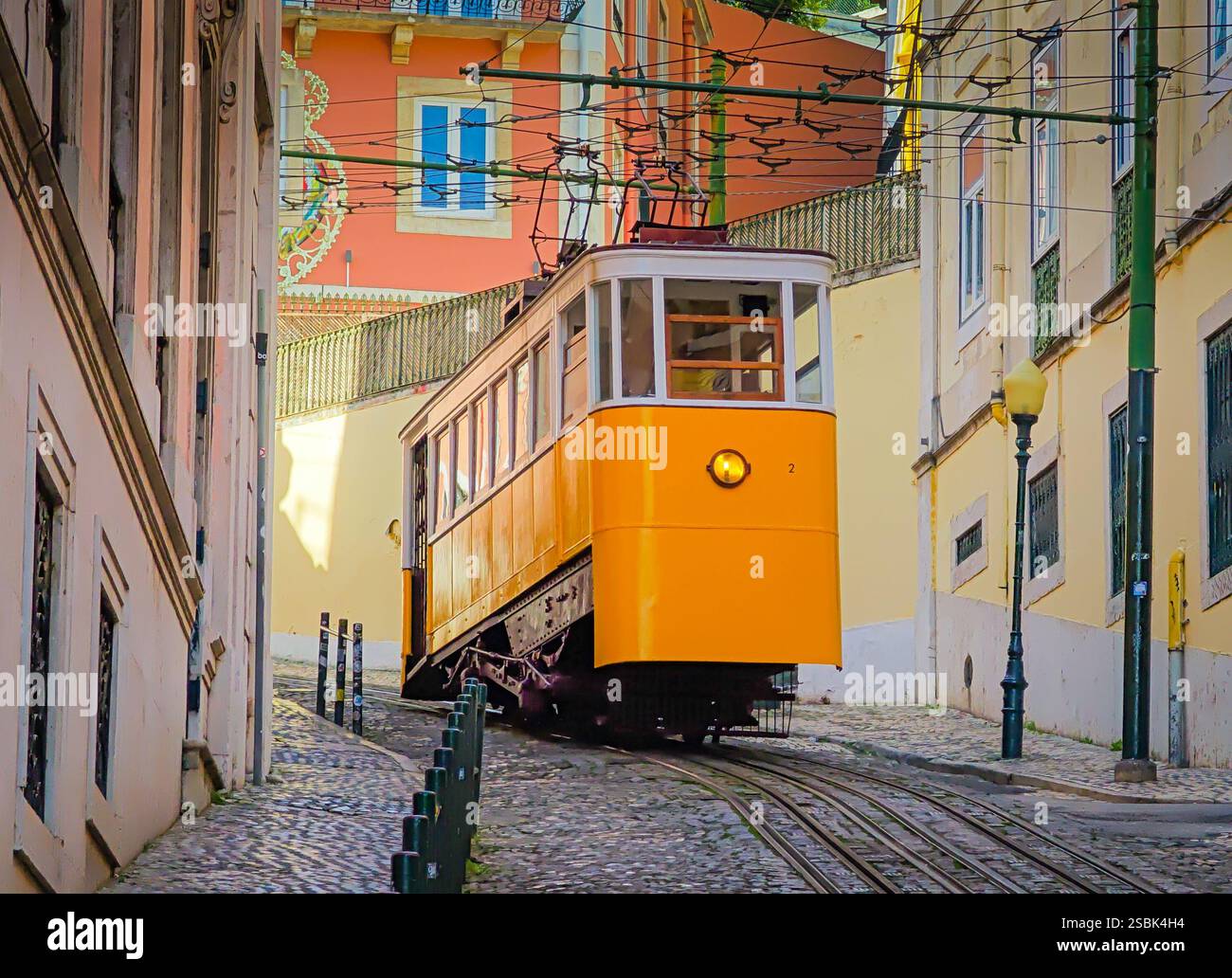 Gloria Funicular in Lisbon. Tram with a wood brass interior climbing a ...