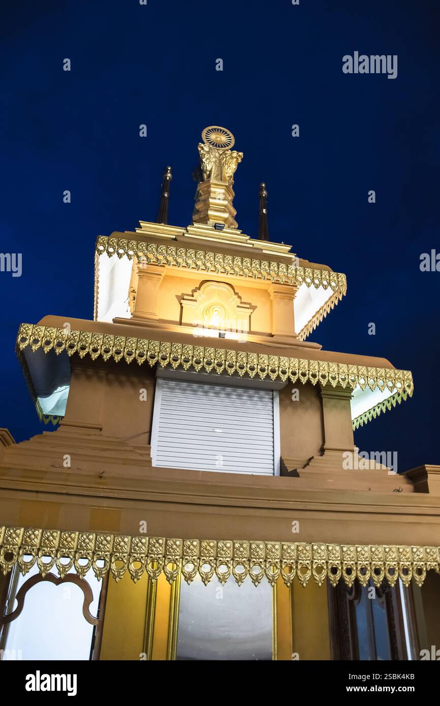 Illuminated rooftop of the Mahamevnawa Amawatura Monastery is under deep blue night sky ...