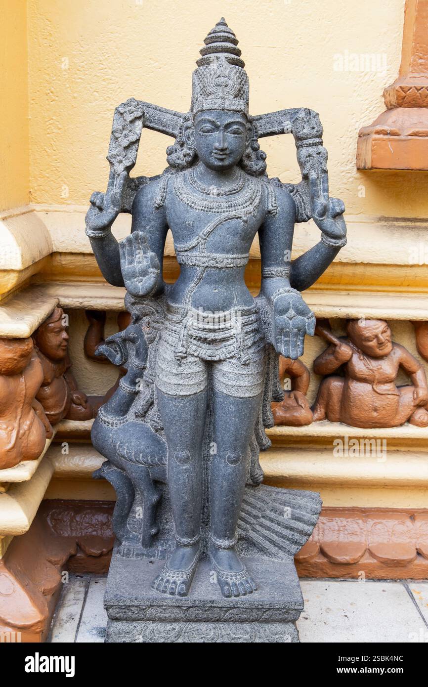 Ancient stone statue stands at the entrance of Gangaramaya Temple. This ...