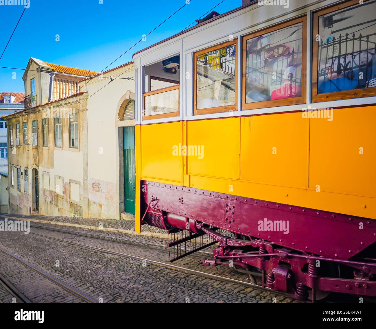 Gloria Funicular in Lisbon. Tram with a wood brass interior climbing a ...
