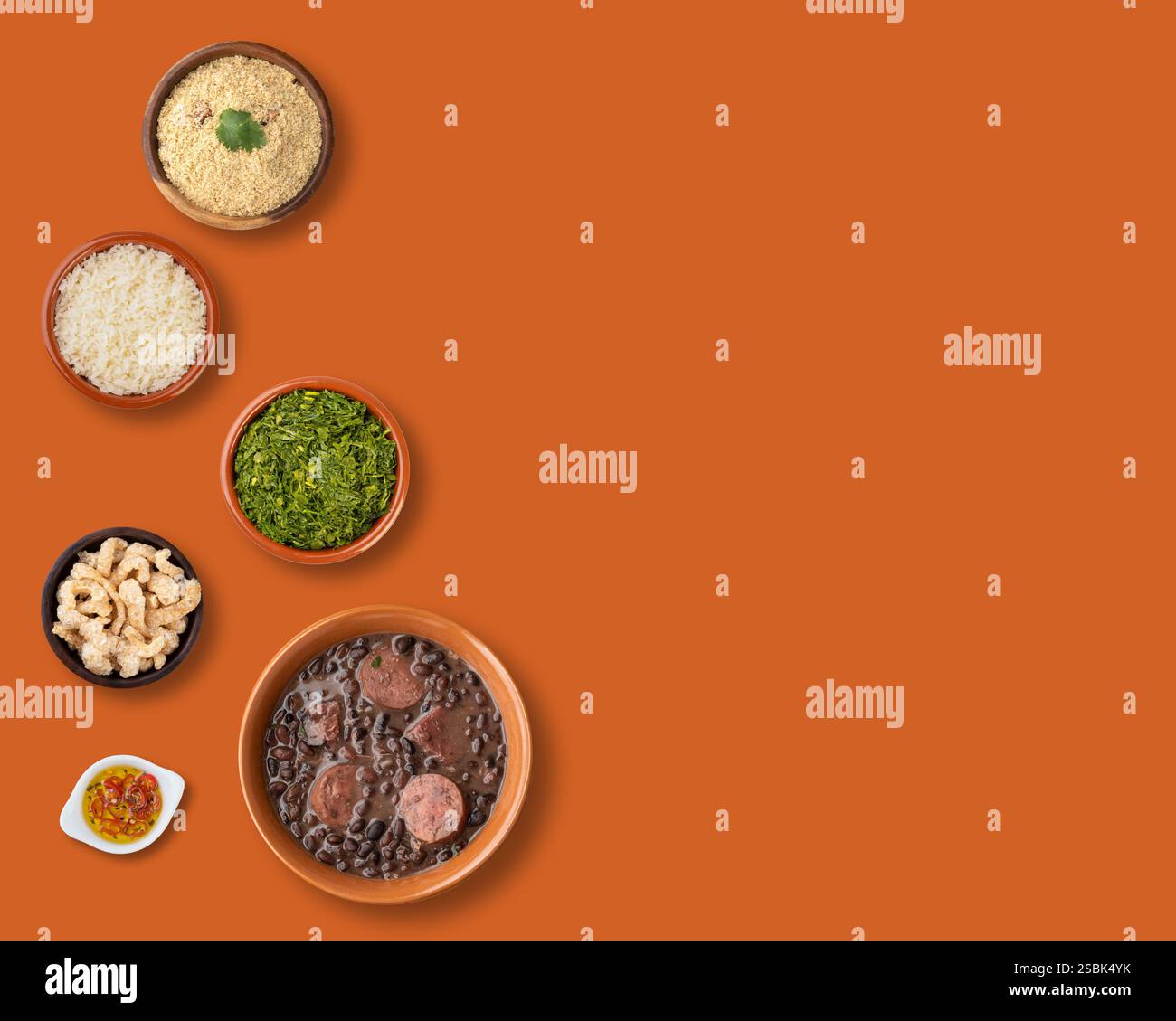Traditional brazilian feijoada with rice, kale, manioc flour ...