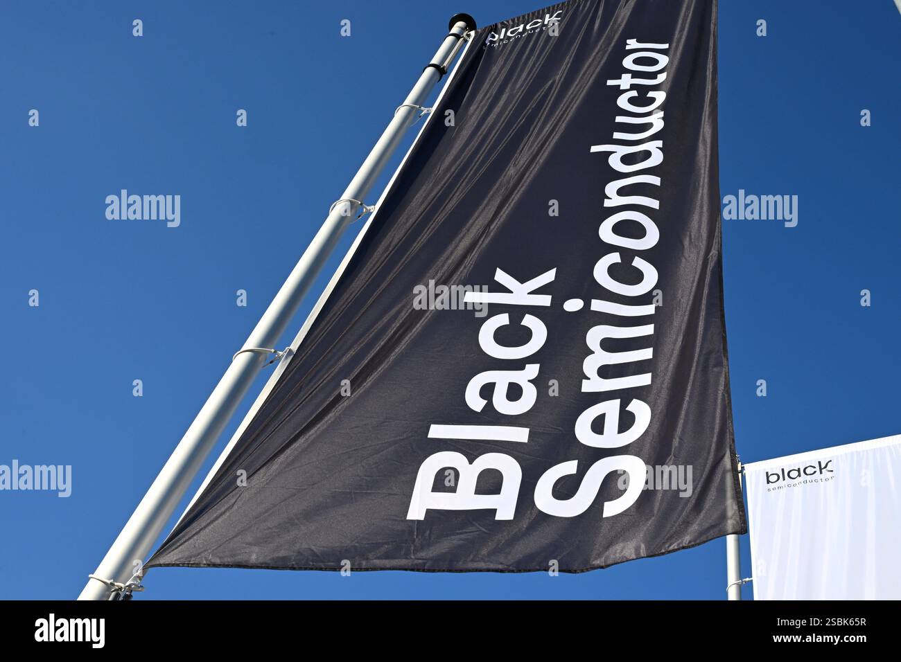 PRODUCTION - 03 February 2025, North Rhine-Westphalia, Aachen: A flag from semiconductor ...