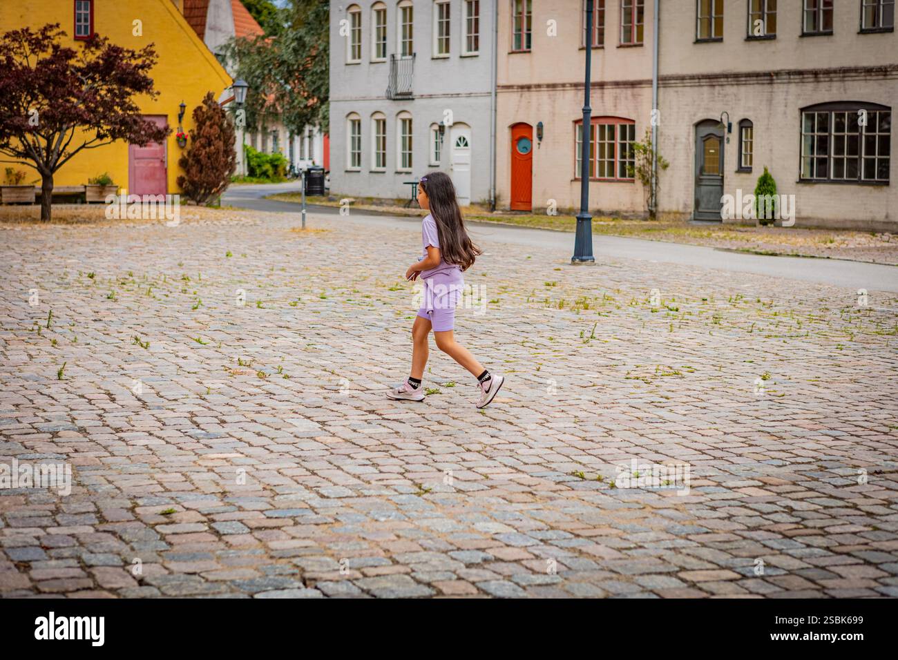 Girl running through medieval and Hansa inspired living area Jakriborg ...