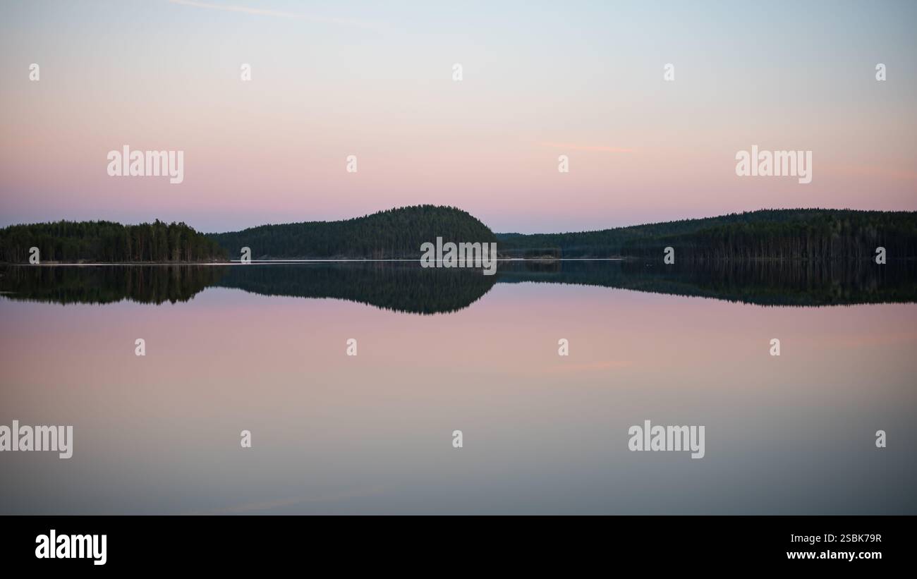 Lake scenery around sunset on a late spring evening in conifer forests ...
