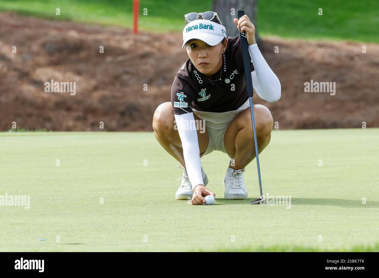 Lydia Ko, of New Zealand, lines up her putt on the second green during the final round of the ...