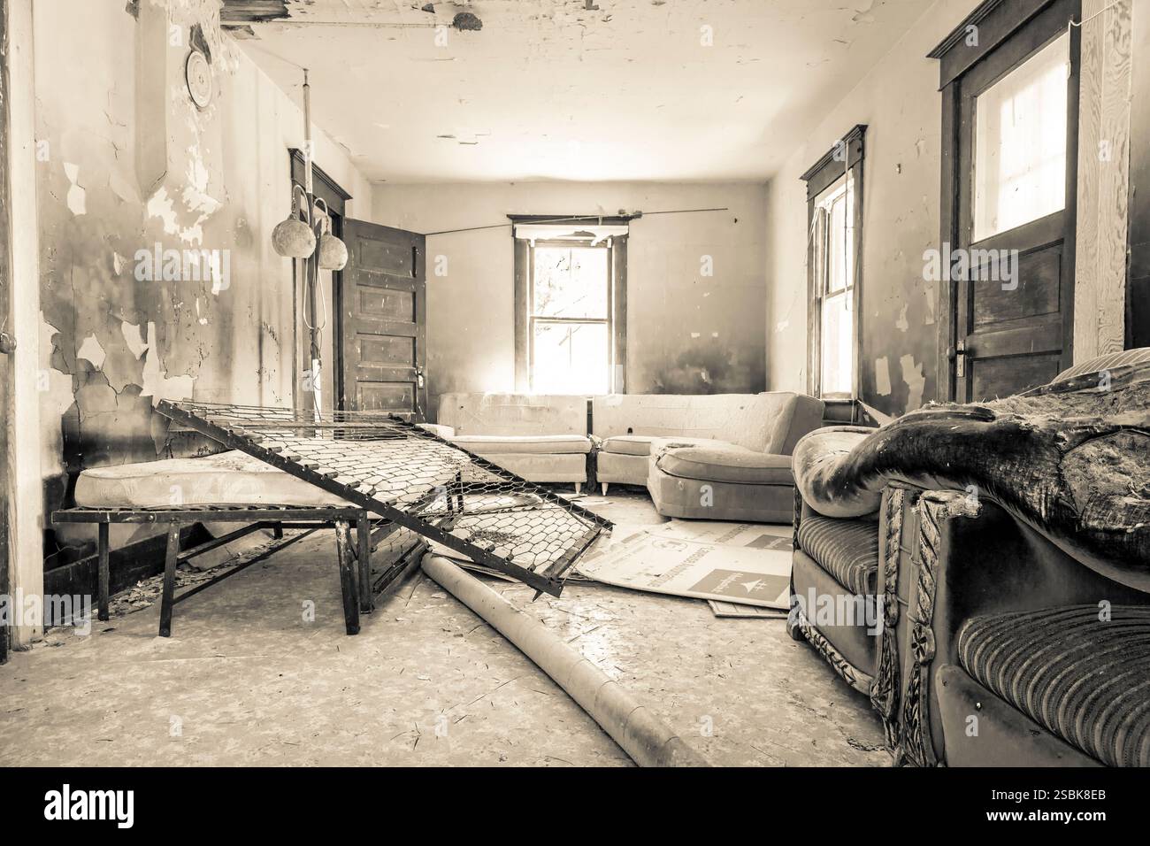 Room with a bed, couch, and chair. The bed is broken and the couch is ...