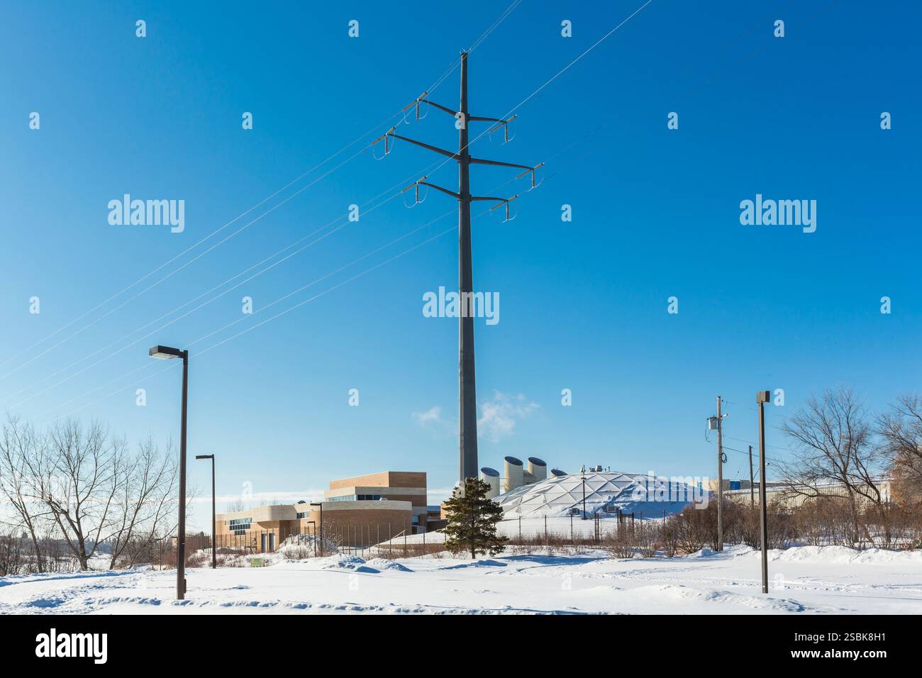 A tall power pole with wires on top. The pole is in the middle of a ...