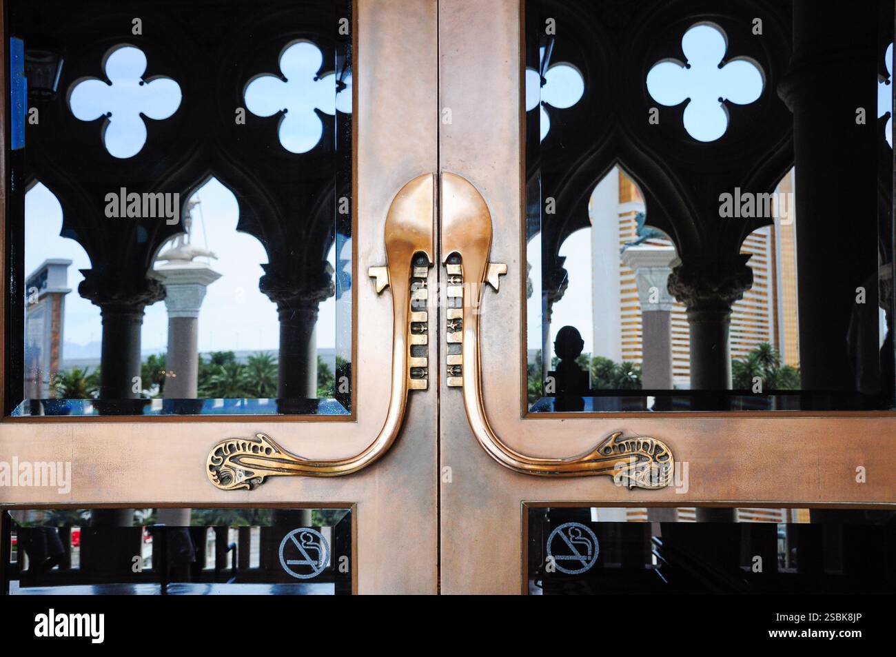 Ornate glass doors with intricate handles open to a view of Las Vegas ...