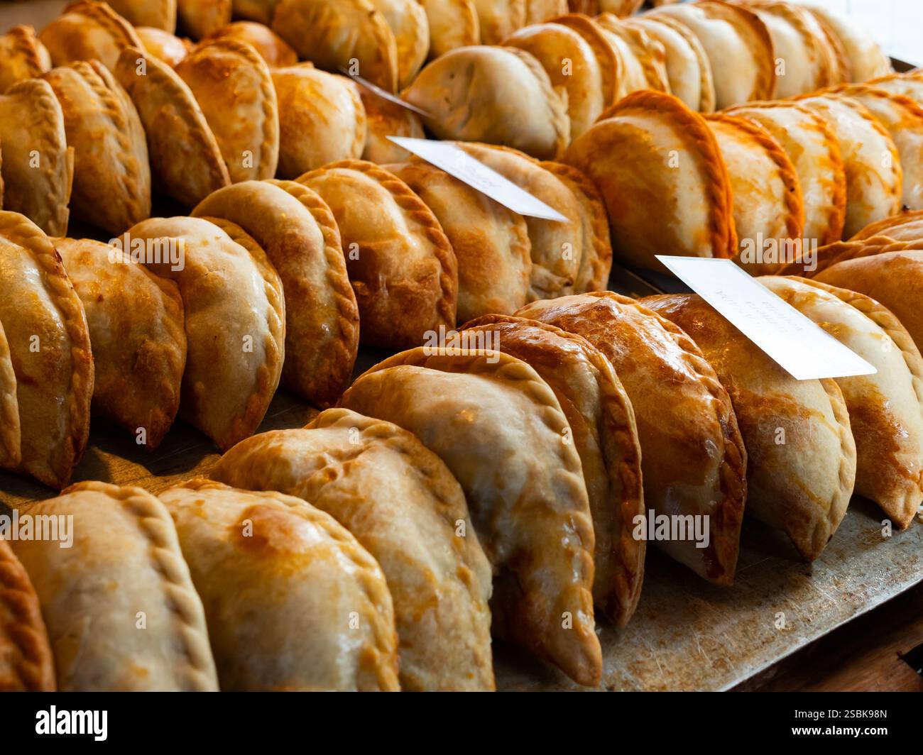 Baked snack empanada at market Stock Photo - Alamy