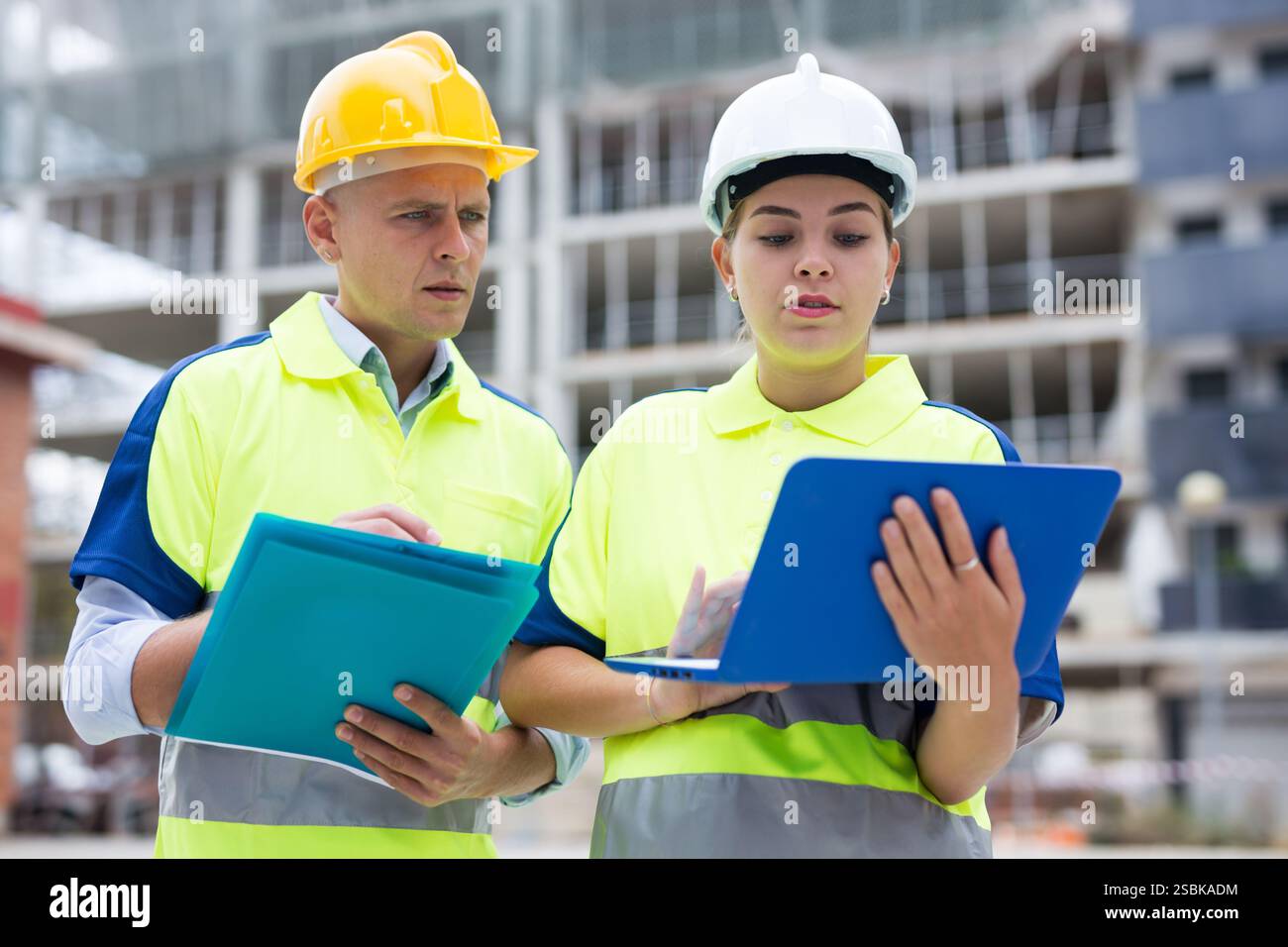 Two builders planning their work in construction plant Stock Photo - Alamy