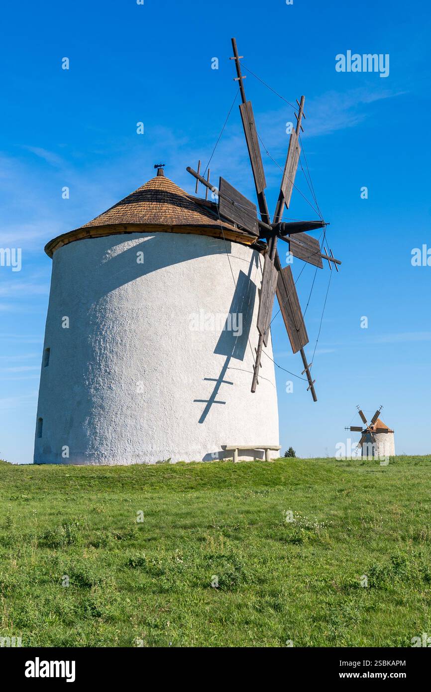 Rustic stone windmill in a grassy field Stock Photo - Alamy