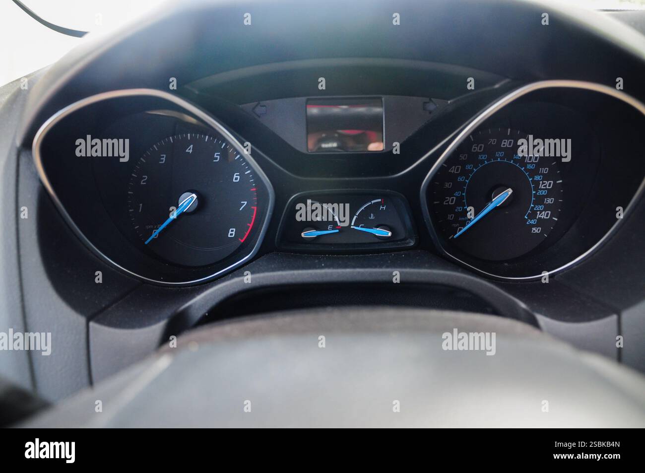 Modern car dashboard with sleek speedometer and fuel gauge close-up ...