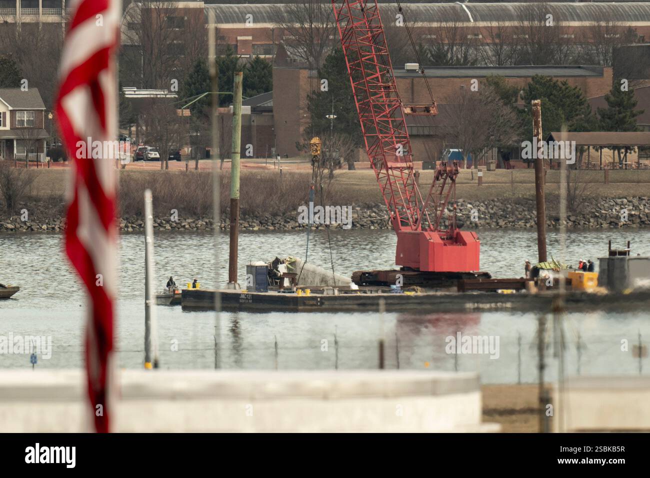Recovery salvage experts lift a wing of the American Eagle wreckage ...