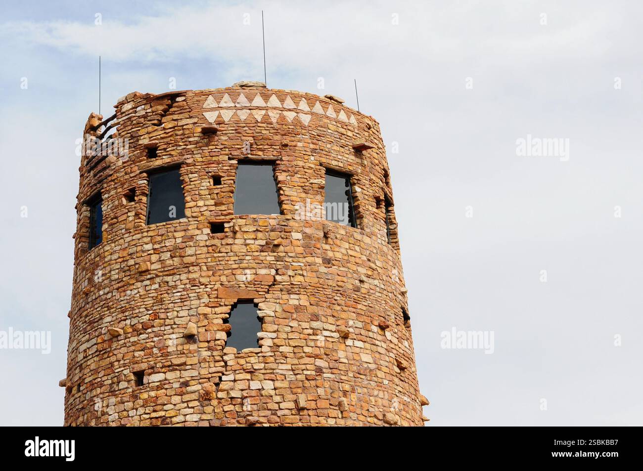Historic stone watchtower at canyon edge under cloudy sky Stock Photo ...
