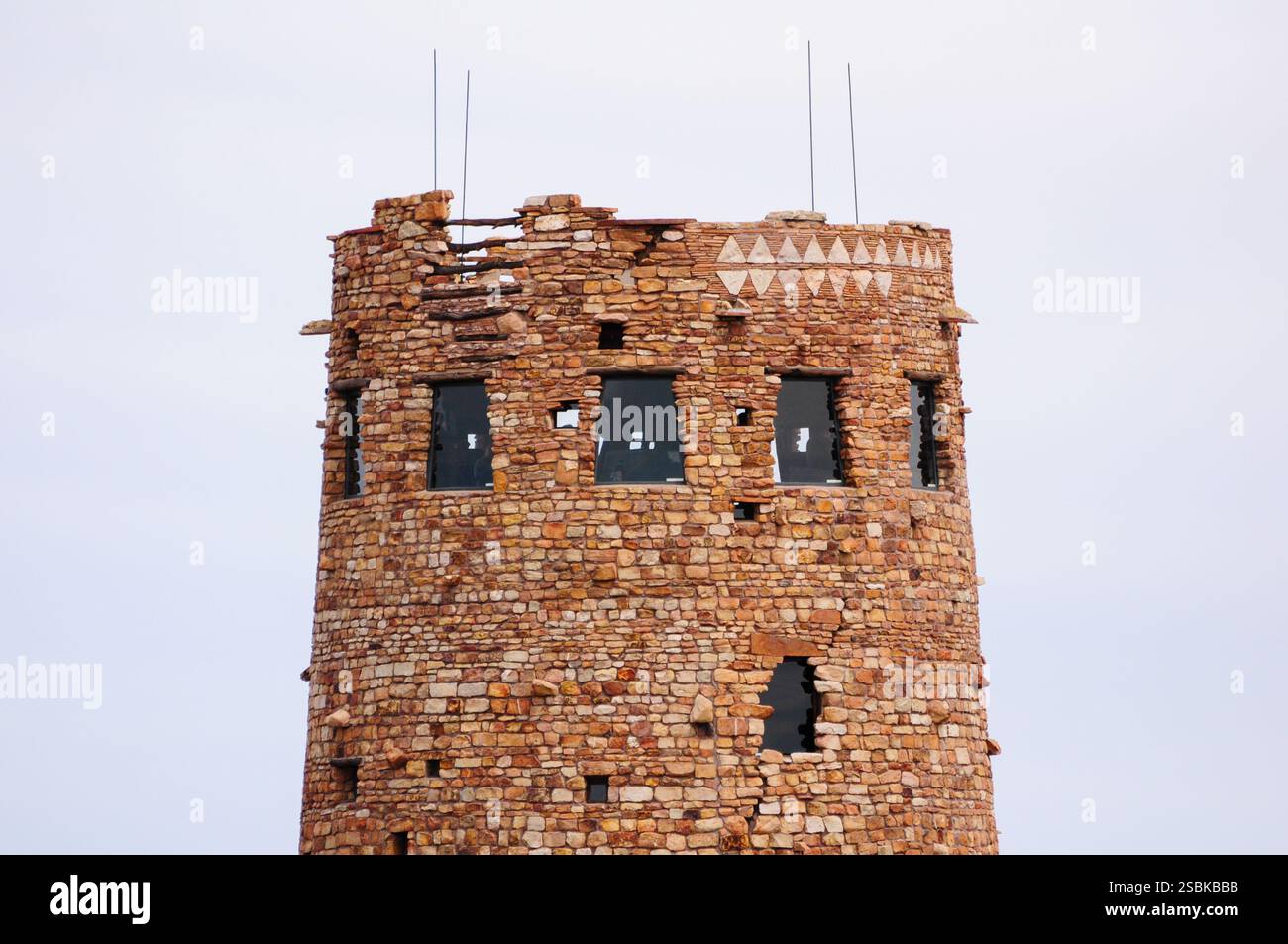 Historic stone watchtower with weathered textures against pale sky ...