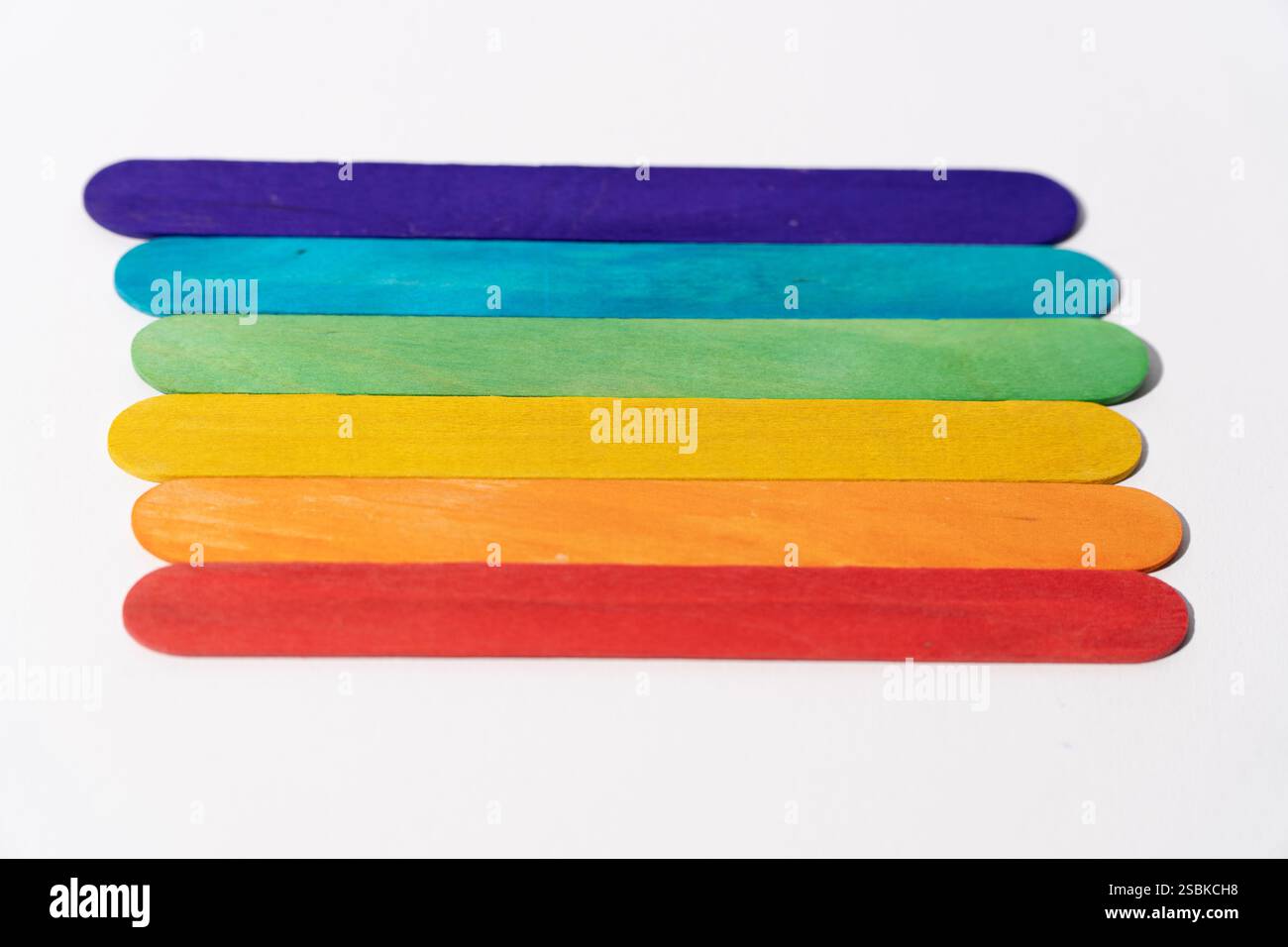 six wood sticks with rainbow colors on white background Stock Photo - Alamy