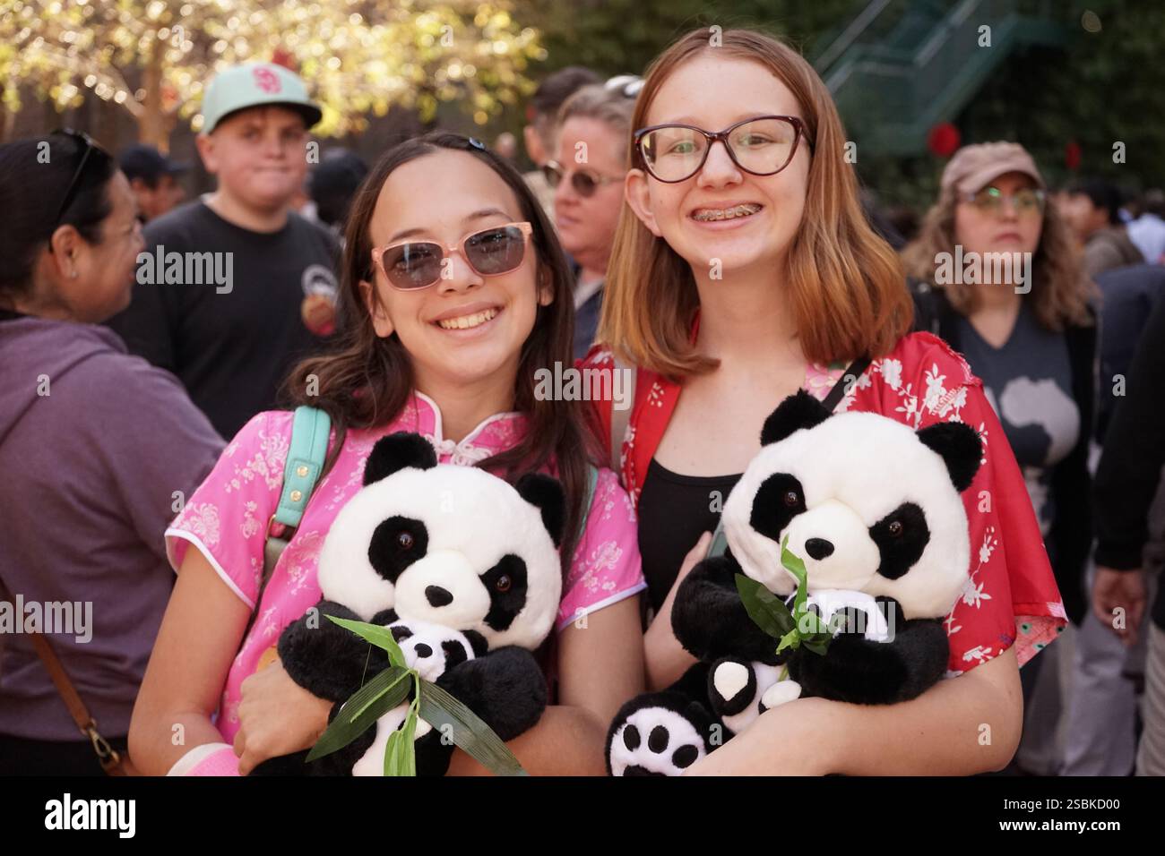 San Diego, USA. 2nd Feb, 2025. Two girls holding giant panda dolls pose ...