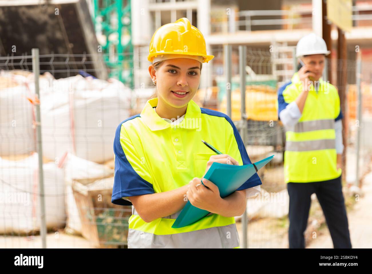Portrait of a young confident female process engineer writing work ...