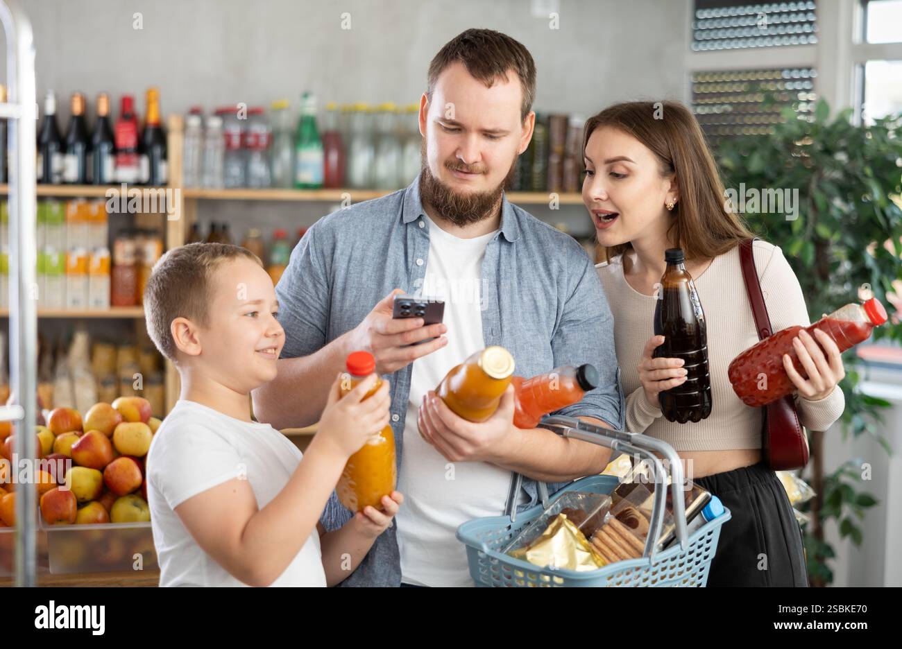 Couple of man and woman with boy scanning qr code of juices Stock Photo ...