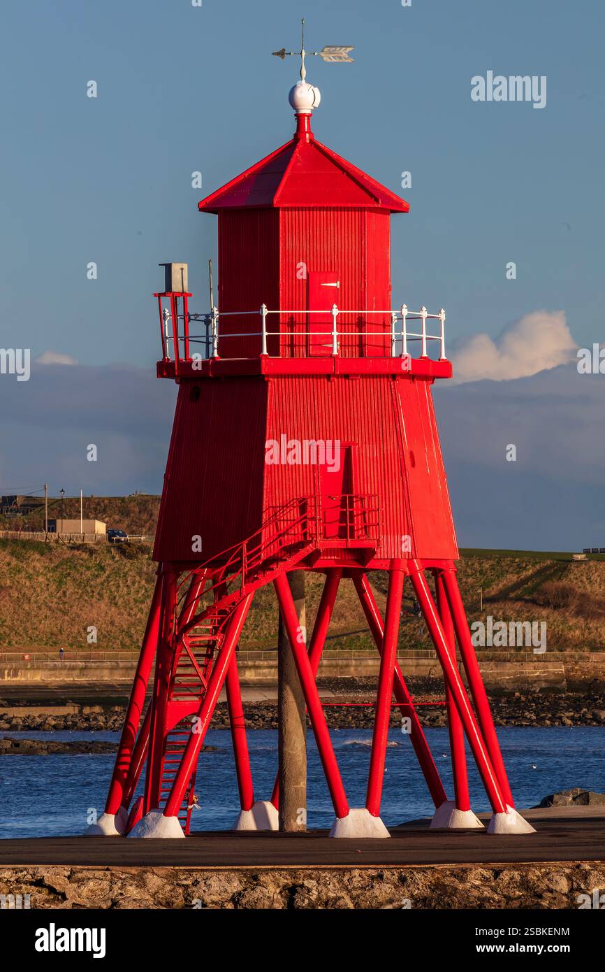 A view in early morning under sunny skies of the Herd Groyne Lighthouse ...