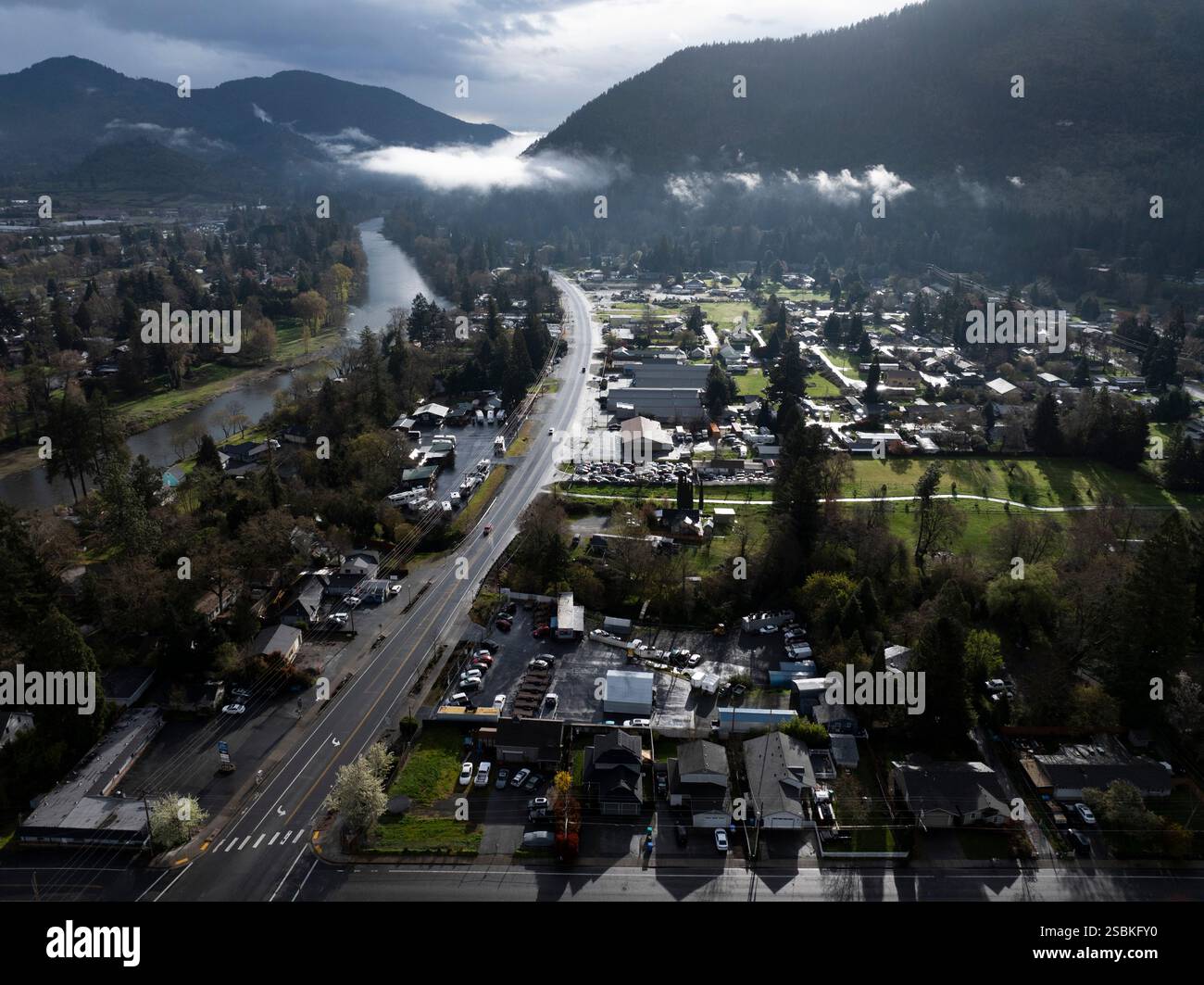 FILE - Vehicles drive down Rogue River Highway as light shines on the ...