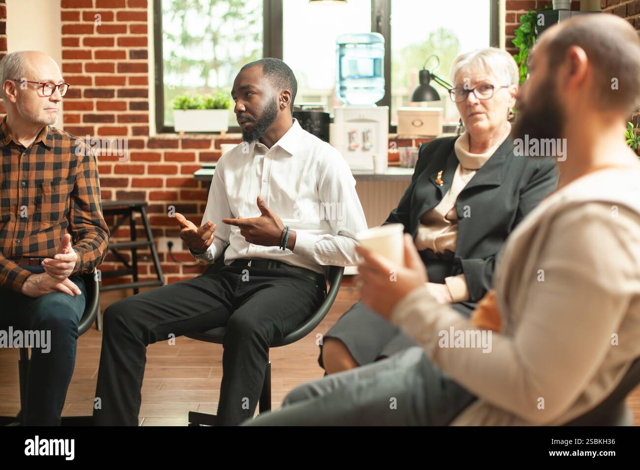 Young black guy sharing his mental health struggles with aa group ...