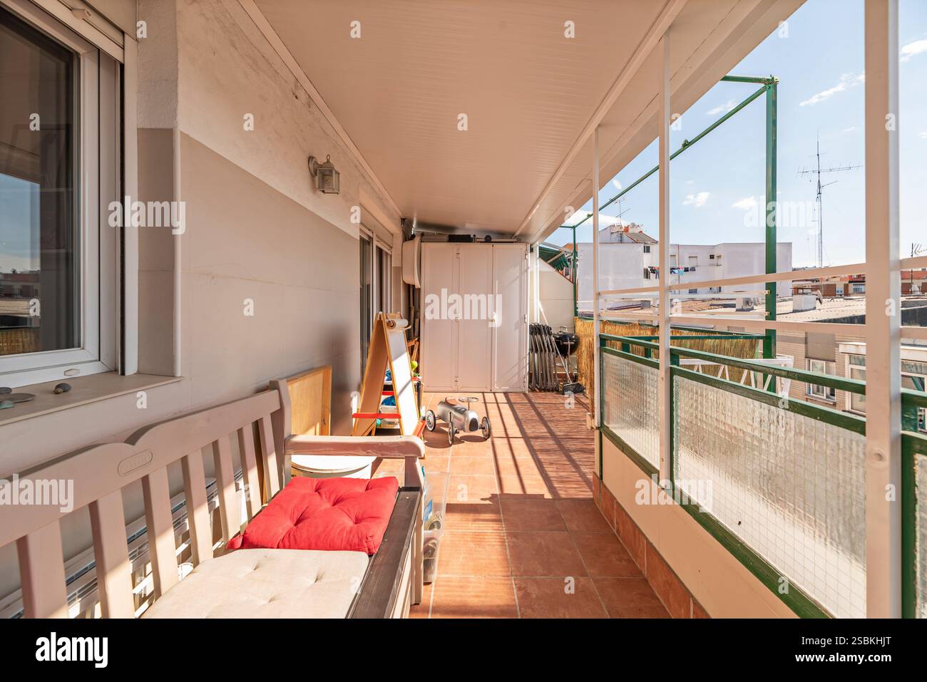 Terrace of a top-floor house with reed decking on the railing and a ...